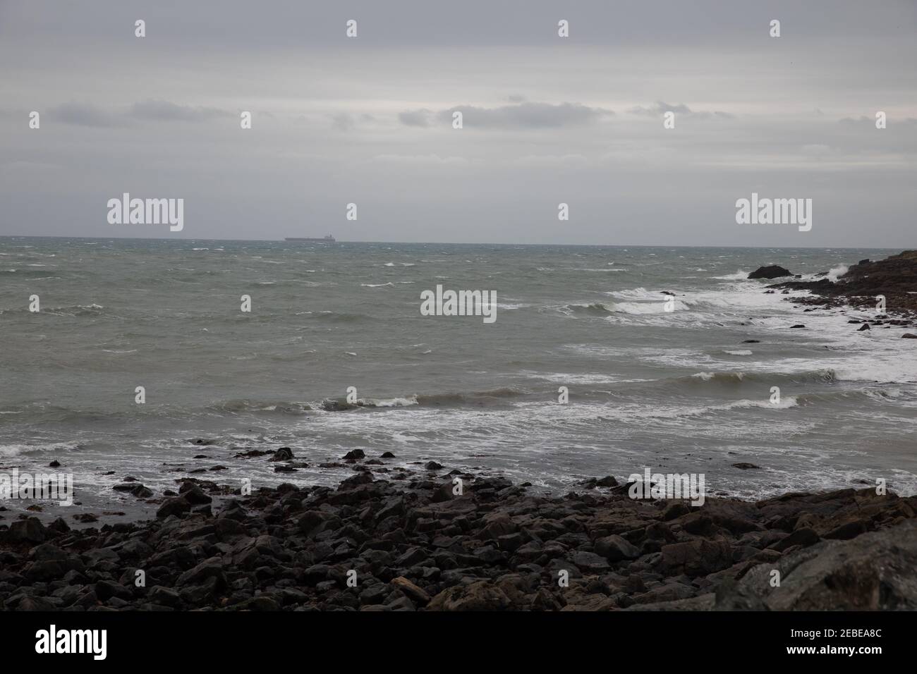Waves crashing over the rocks in Mousehole, Cornwall, UK Stock Photo ...