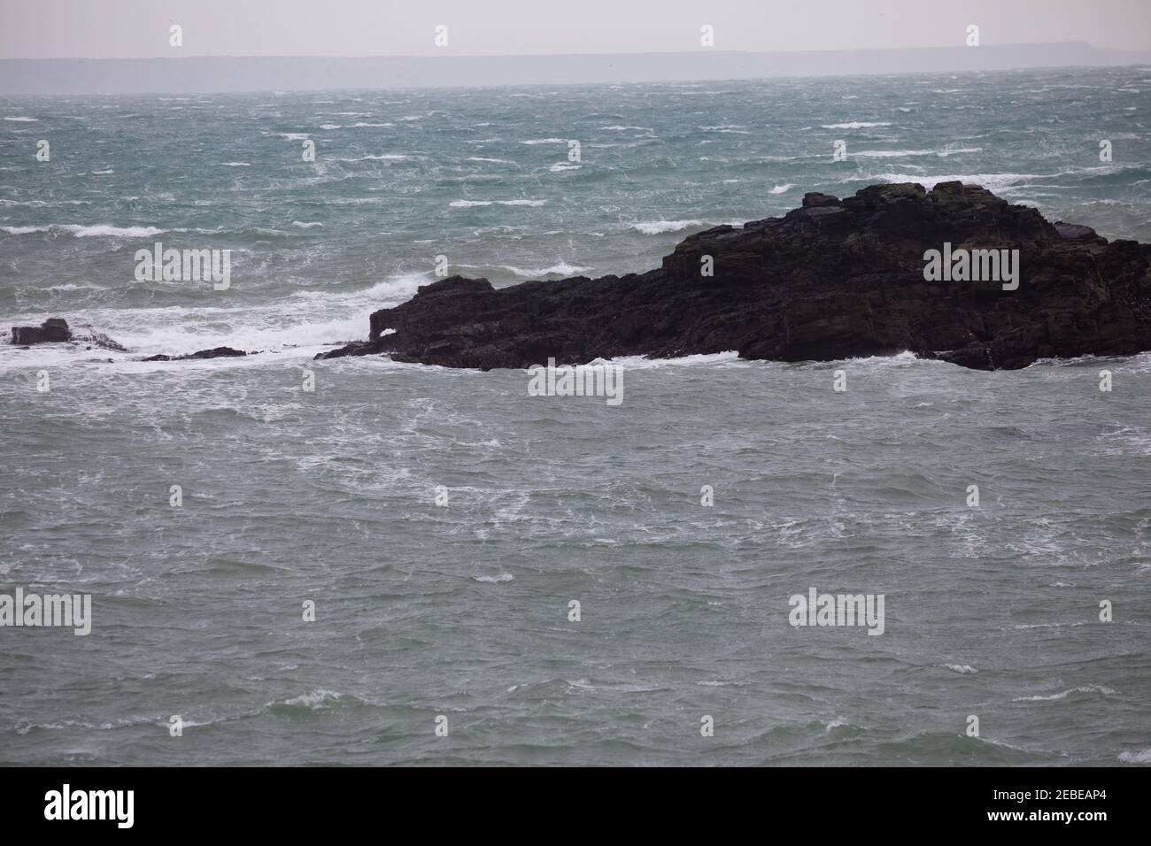 Waves crashing over the rocks in Mousehole, Cornwall, UK Stock Photo ...