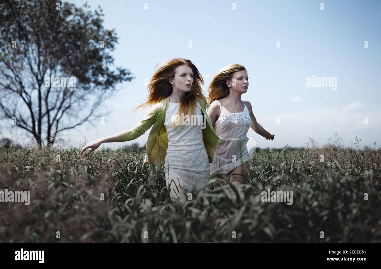Two women running away hi-res stock photography and images - Alamy