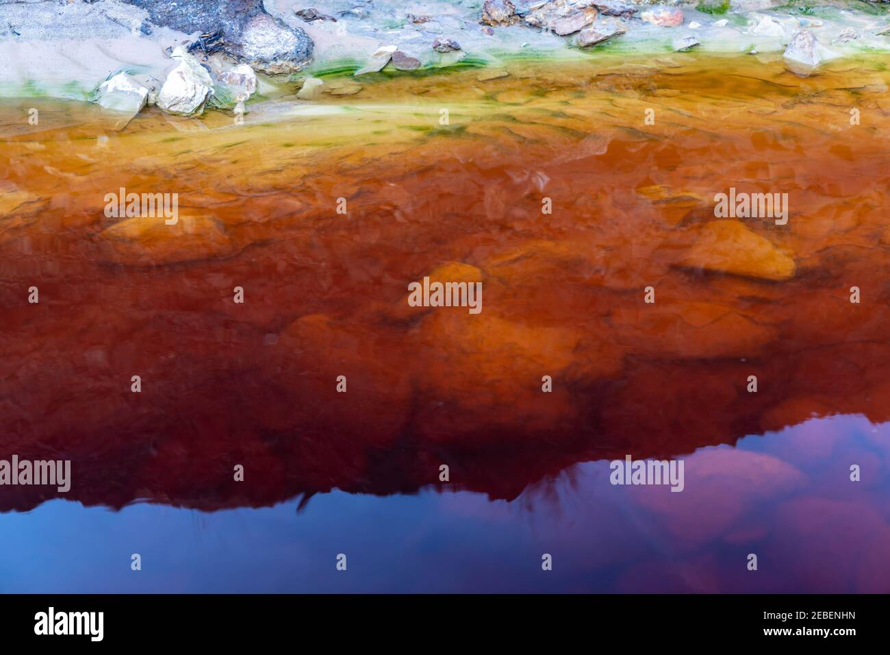 An abstract view of a riverbed in an abandoned mining area with mineral ...