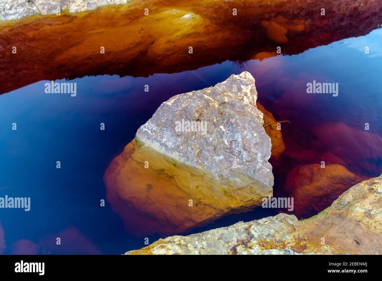 An abstract view of a riverbed in an abandoned mining area with mineral ...