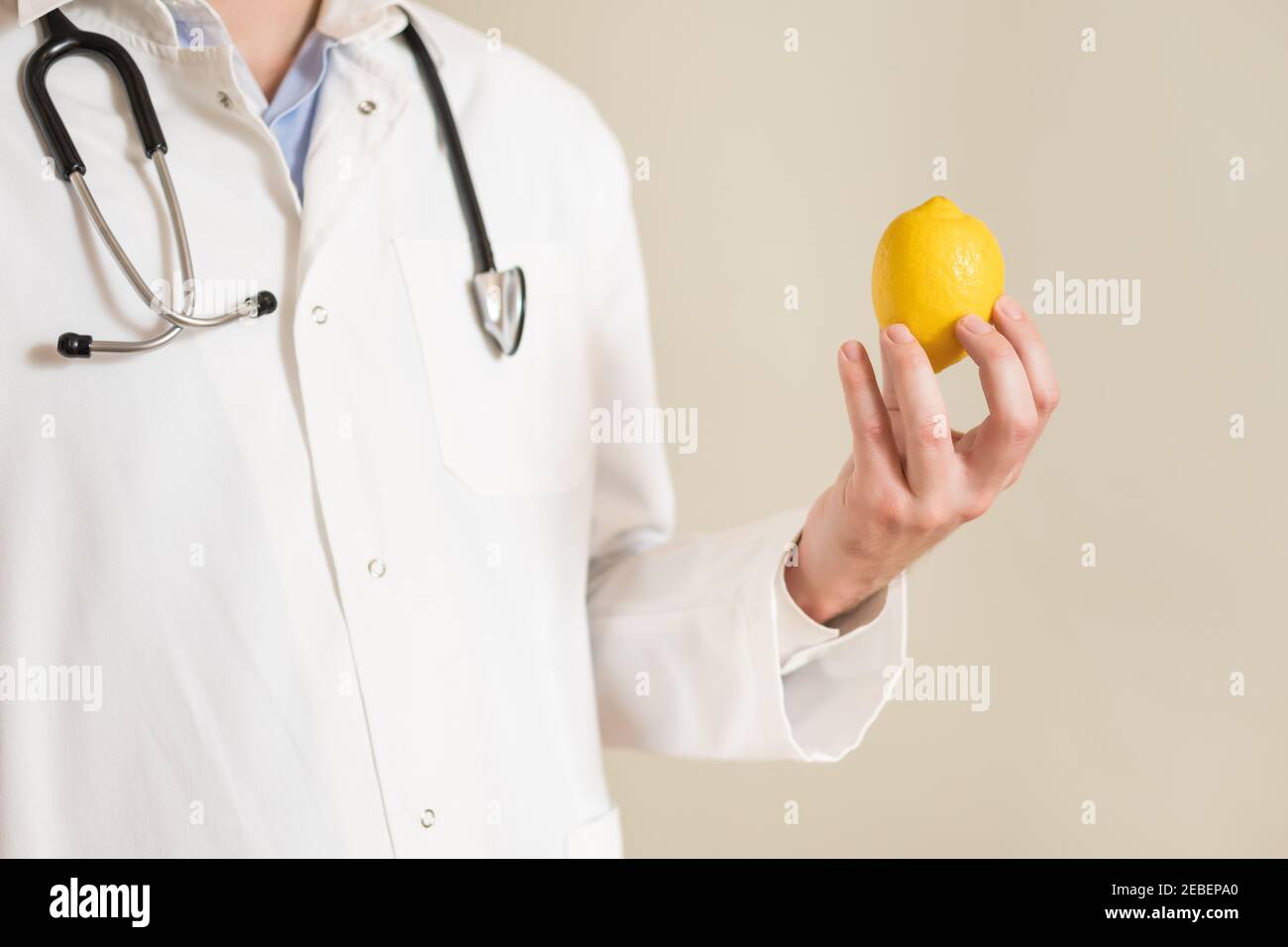 Image of male doctor holding lemon Stock Photo - Alamy