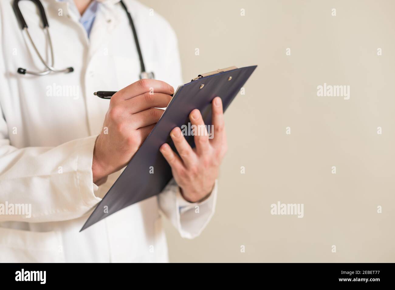 Image of male doctor writing notes Stock Photo - Alamy