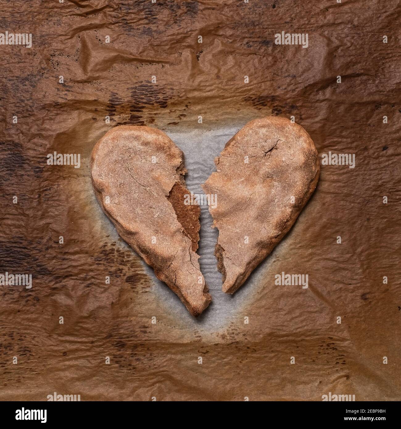 close up of a broken heart made from baked beard on paper. Symbol of ...