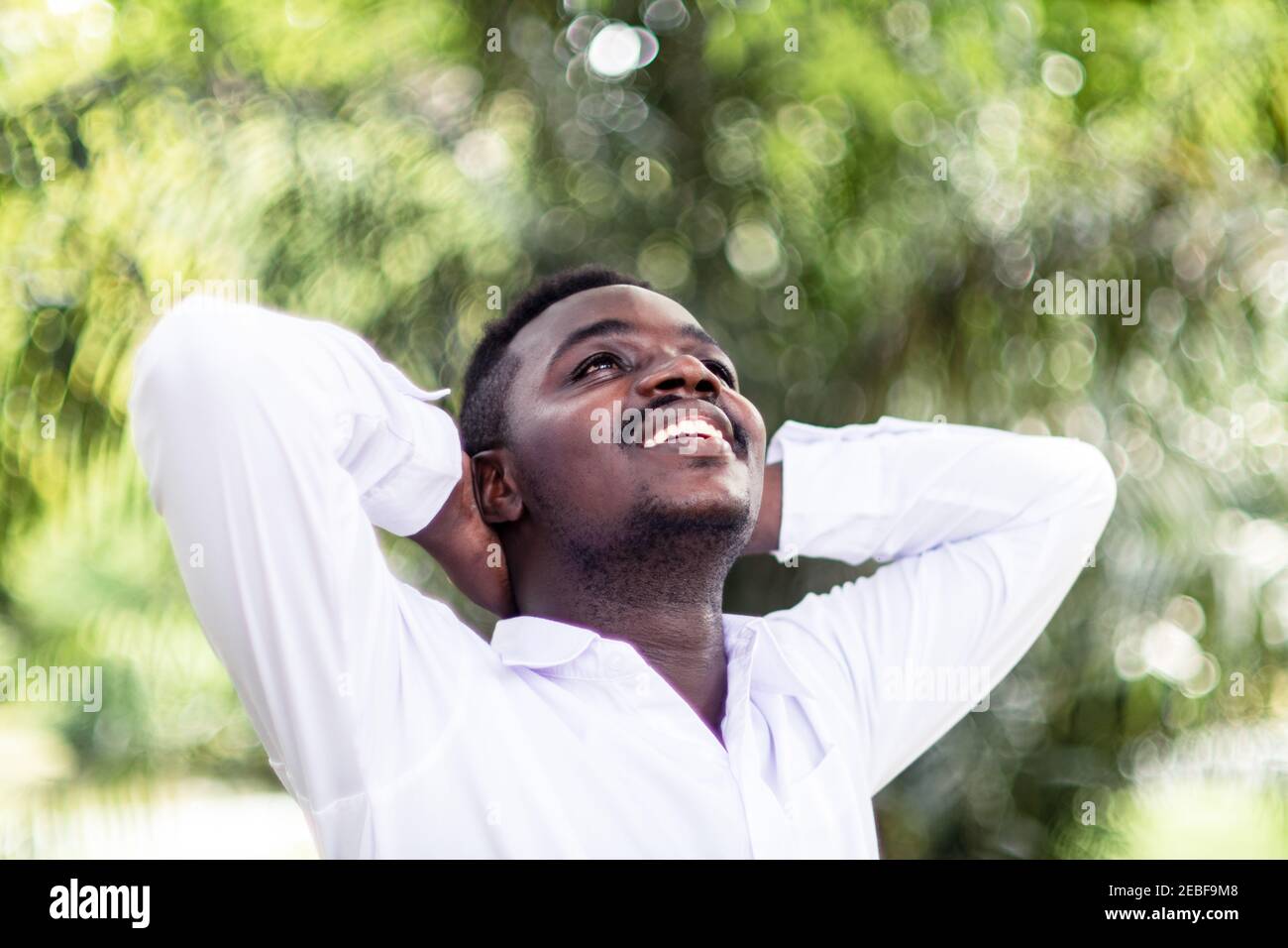 African business man in white shirt smiling and thinking Stock Photo ...