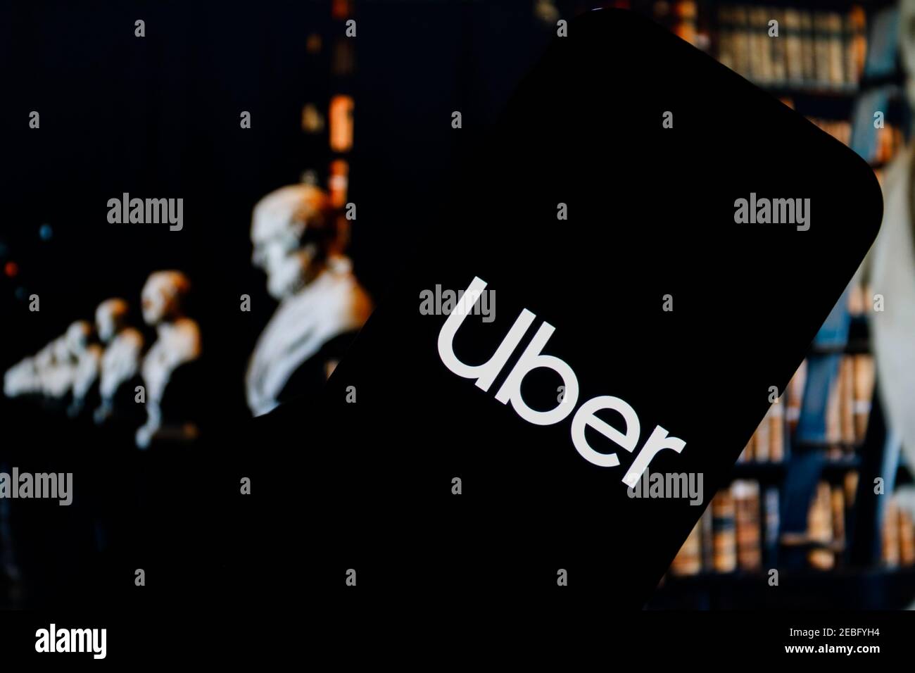 In this photo illustration an Uber company app logo seen displayed on a ...