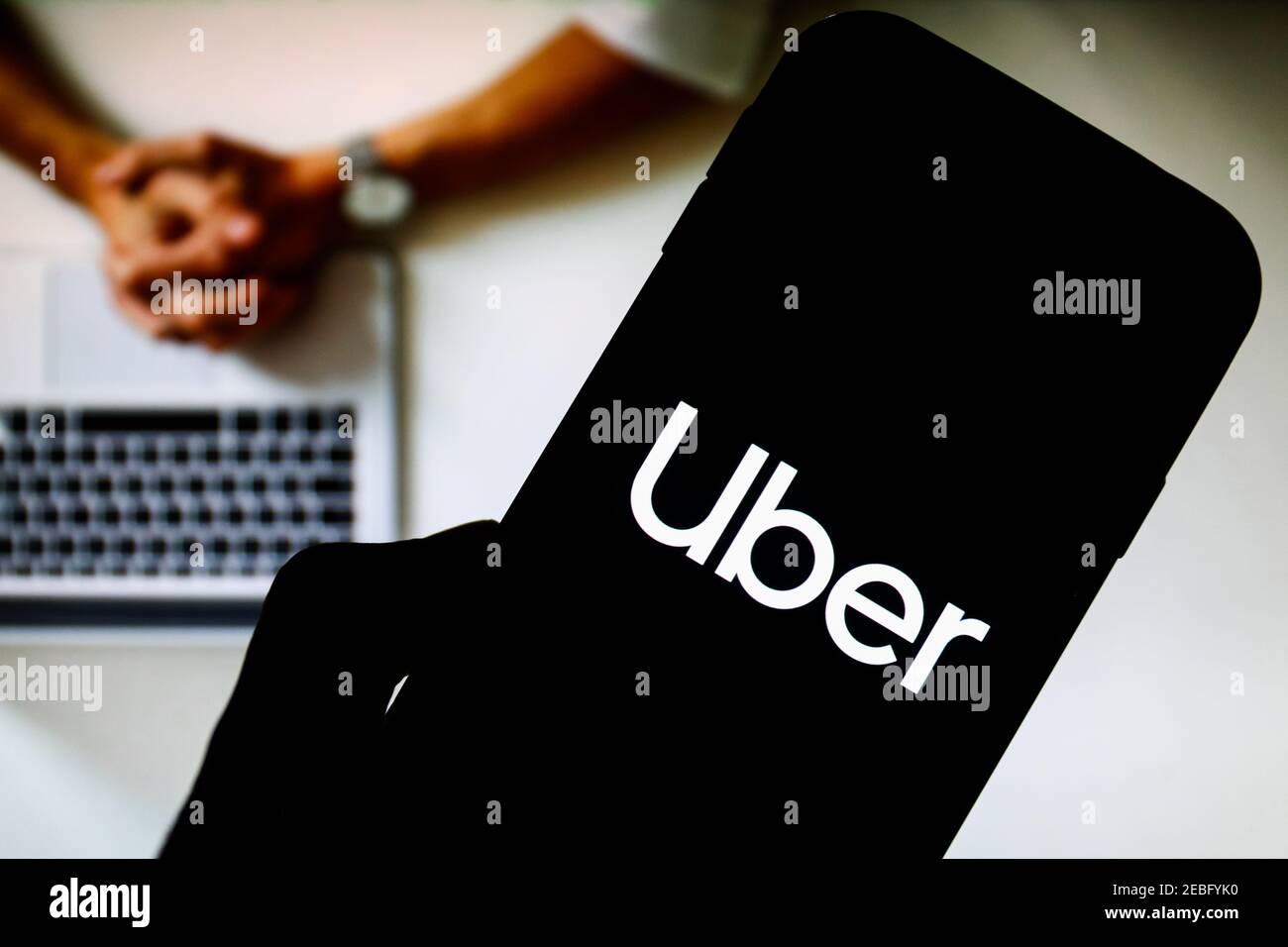 In this photo illustration an Uber company app logo seen displayed on a ...