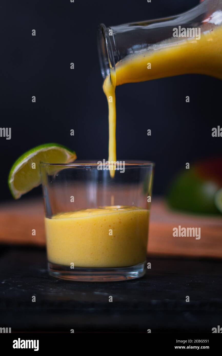 Mango juice poured in glass hi-res stock photography and images - Alamy