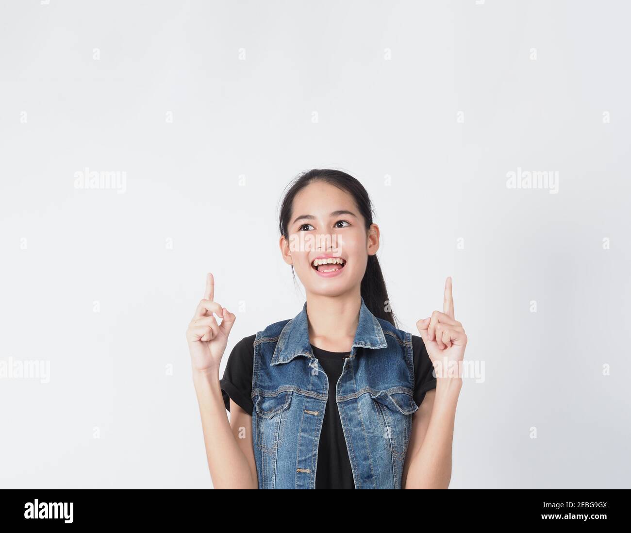 Gesture posing. Asian Young woman on white background cheerful and ...
