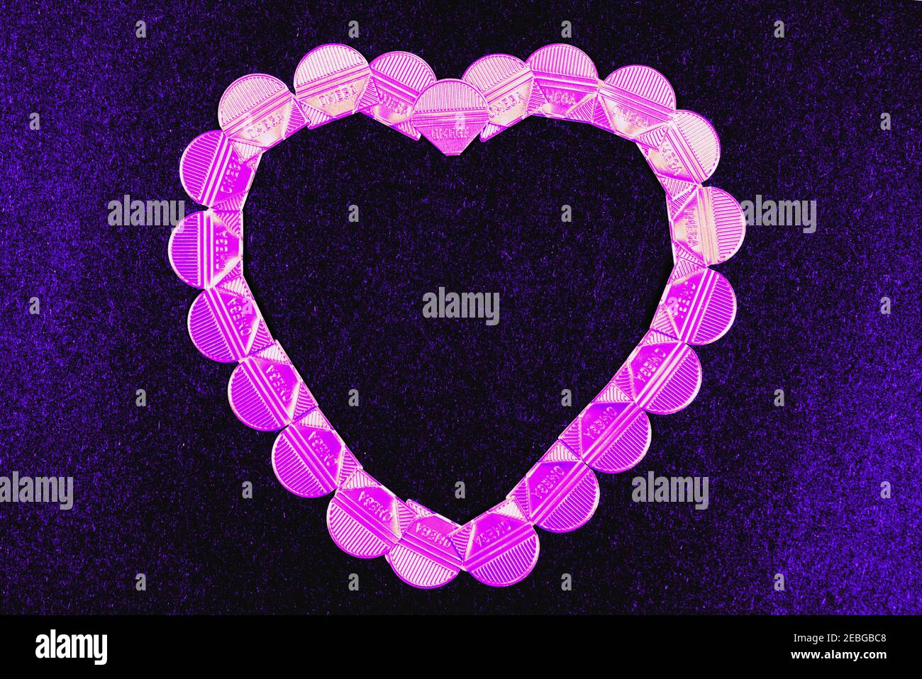 Purple heart on a black background Stock Photo - Alamy