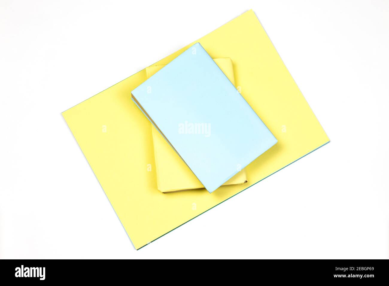 Colorful books and yellow paper on white background. Education concept ...