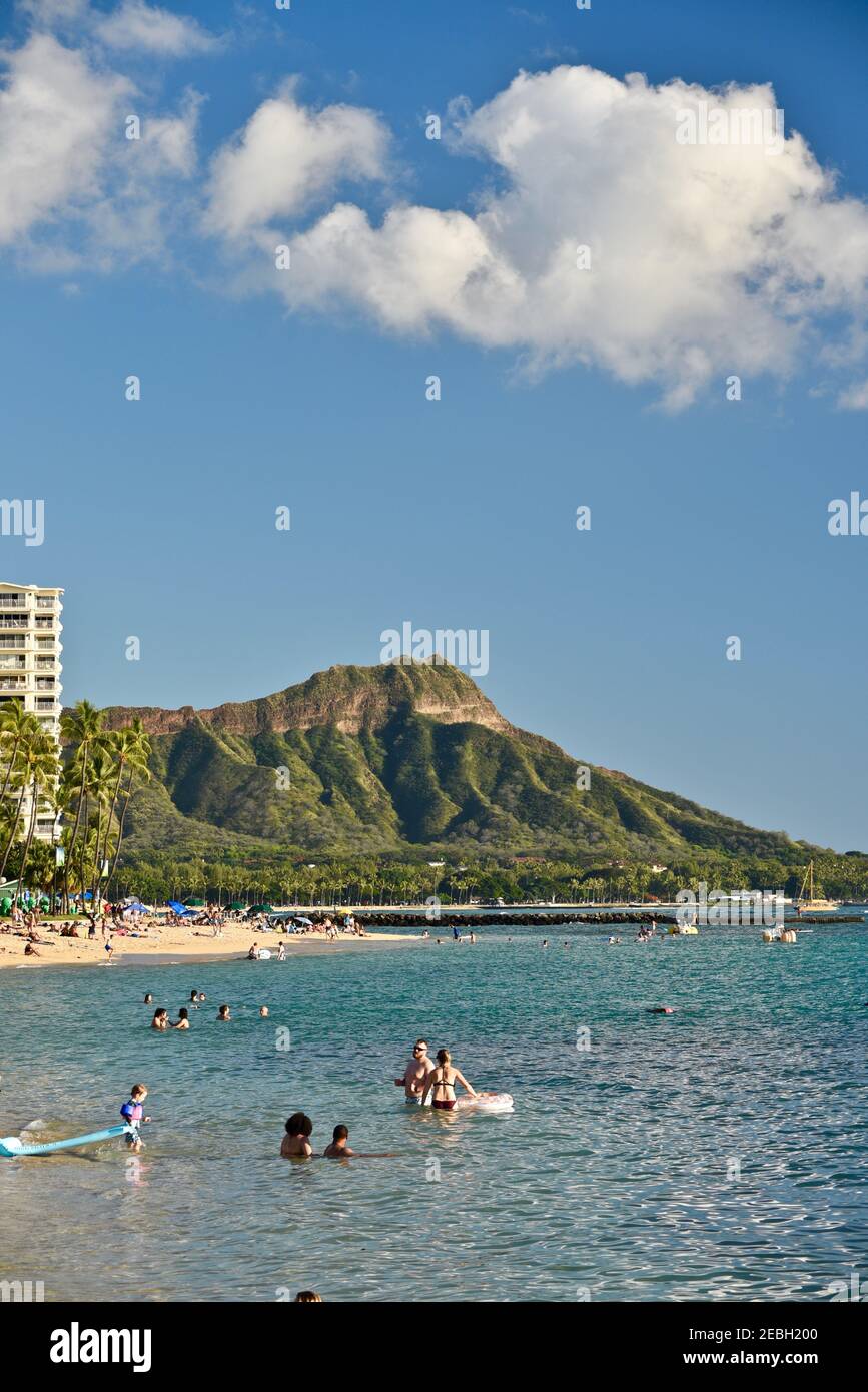People relaxing and sunbathing on the Waikiki Beach, surrounded by ...