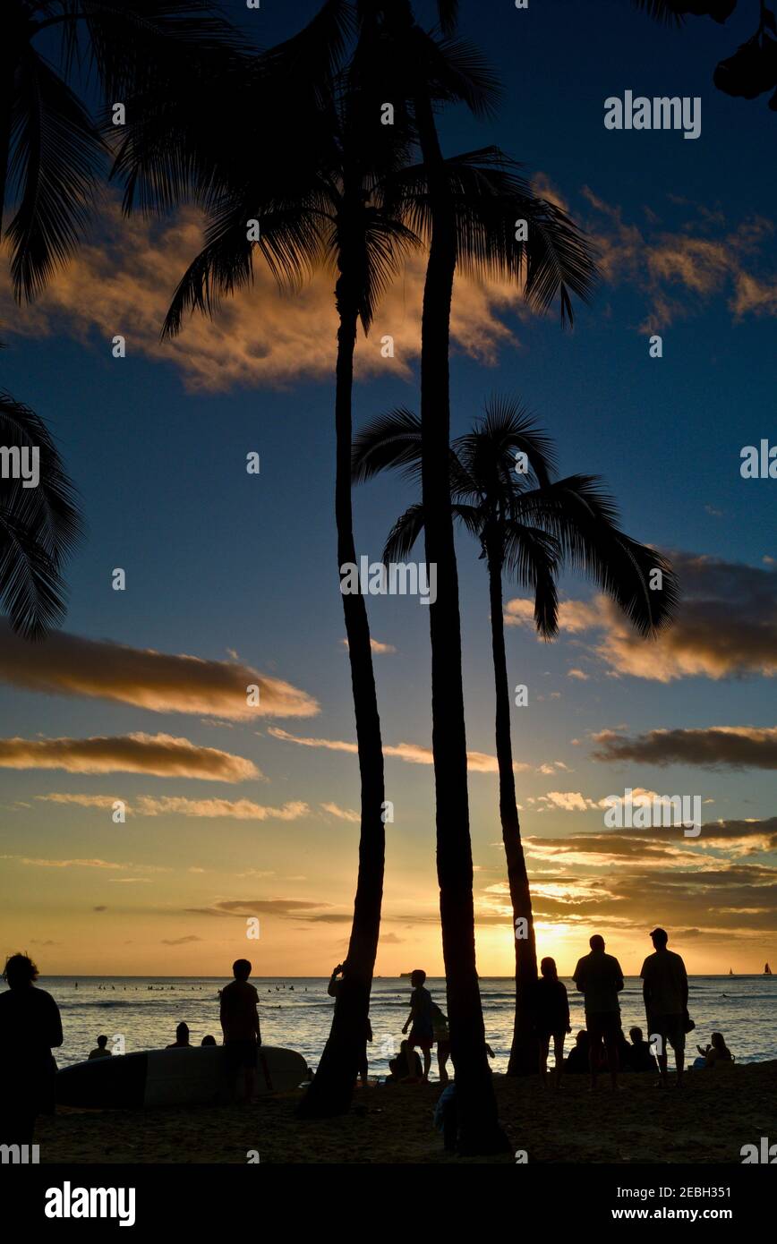 People watching spectacular sunset on the Waikiki Beach, silhouetted by ...