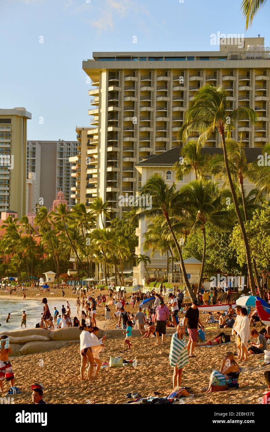 People relaxing and sunbathing on the Waikiki Beach, surrounded by ...