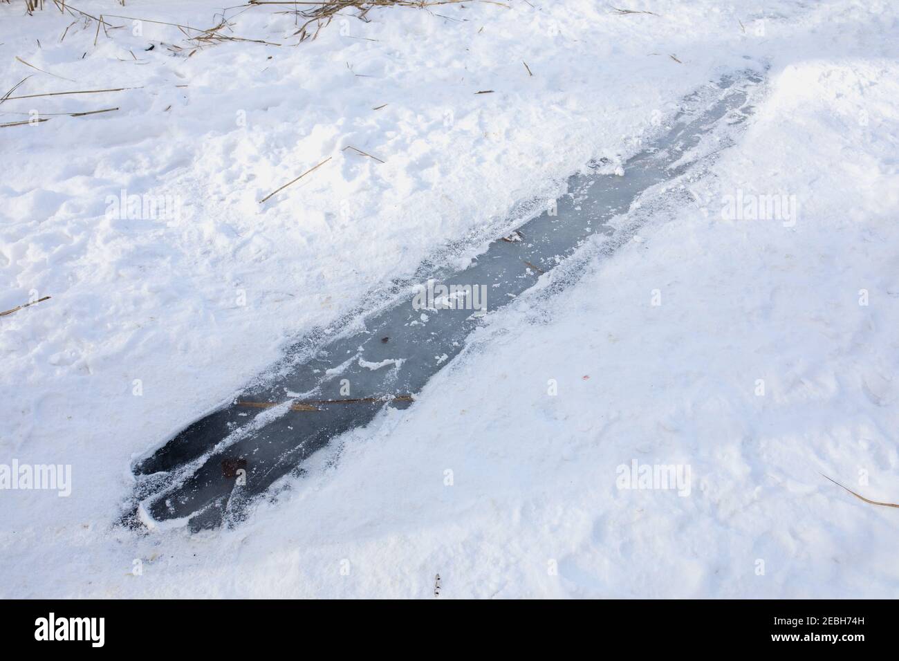 Sliding on a frozen sheet of ice. A slipped section of the path Stock ...