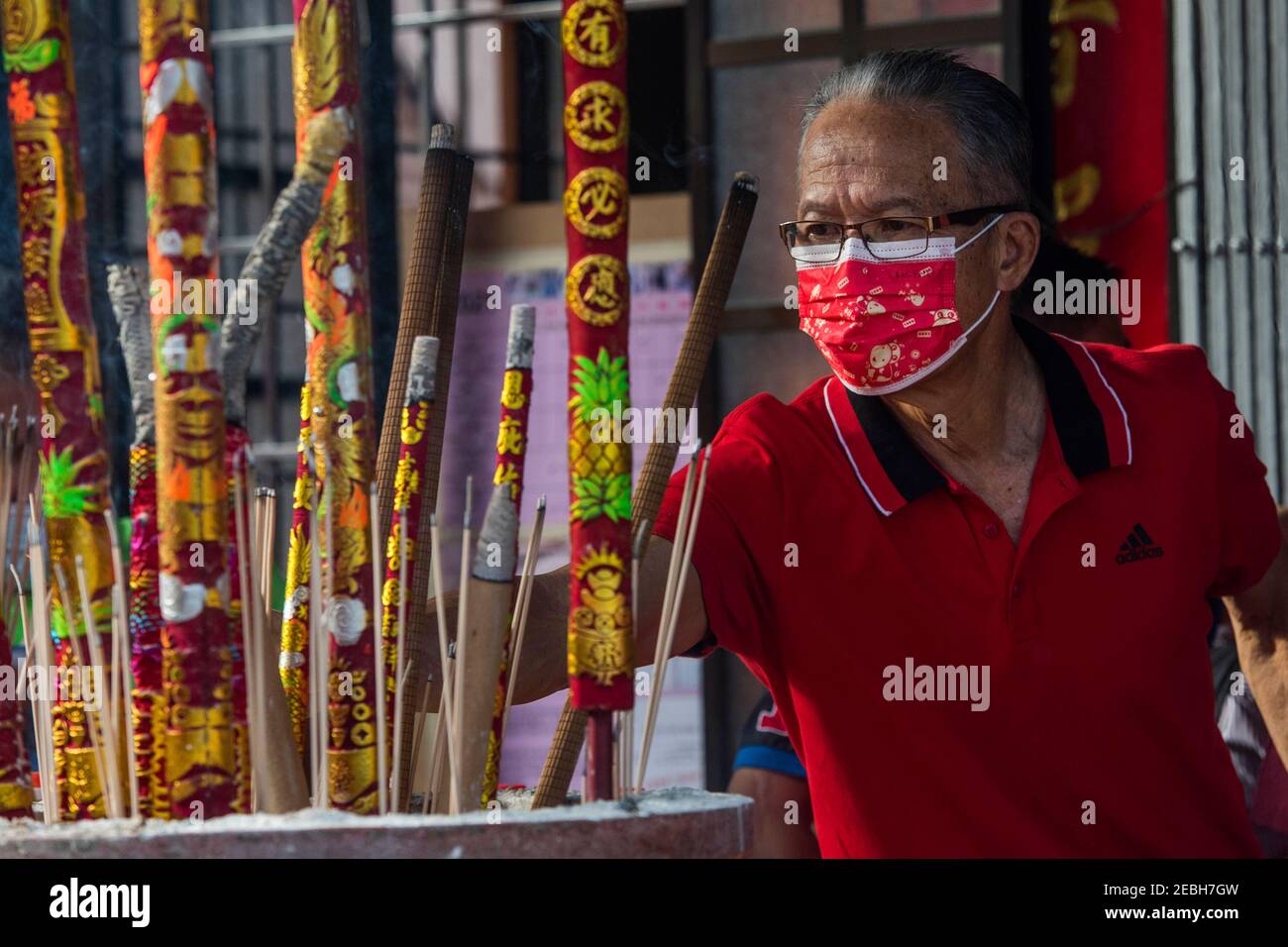 Ethnic Chinese man wearing a Lunar New Year face mask as a preventive ...