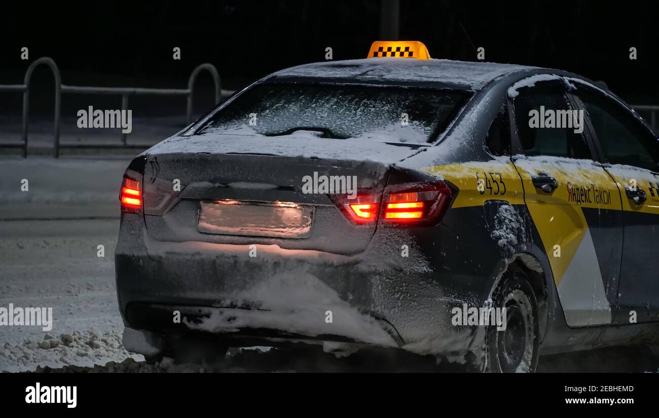 Close-up of a taxi car in winter at night waiting for customers, Yandex ...