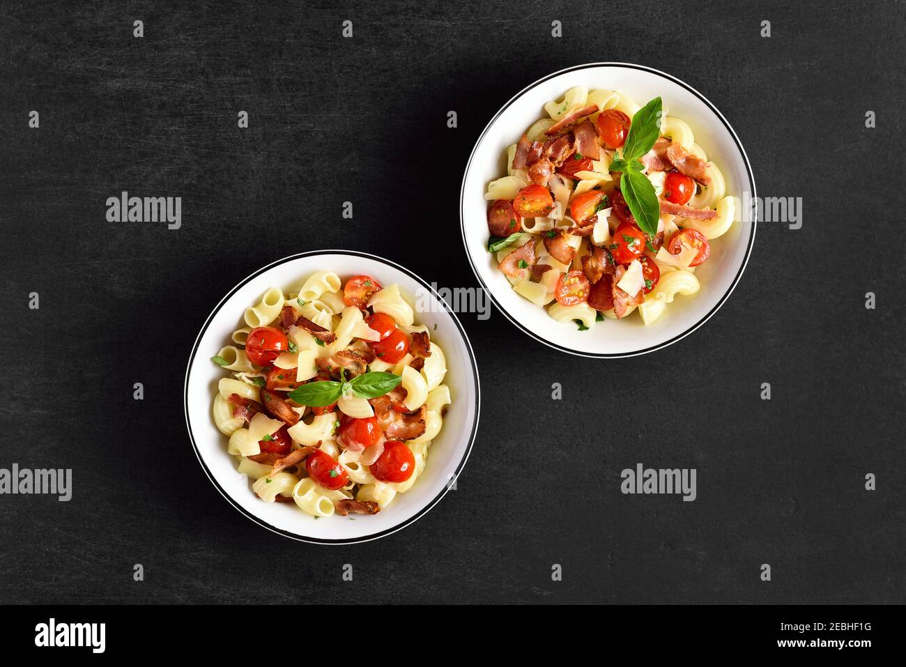 Pasta with bacon, tomato, parmesan cheese and basil leaves on plate ...