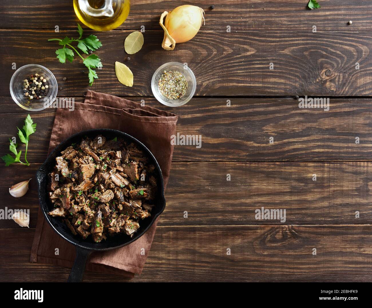 Slow cooked pulled beef in frying pan on wooden background with free ...