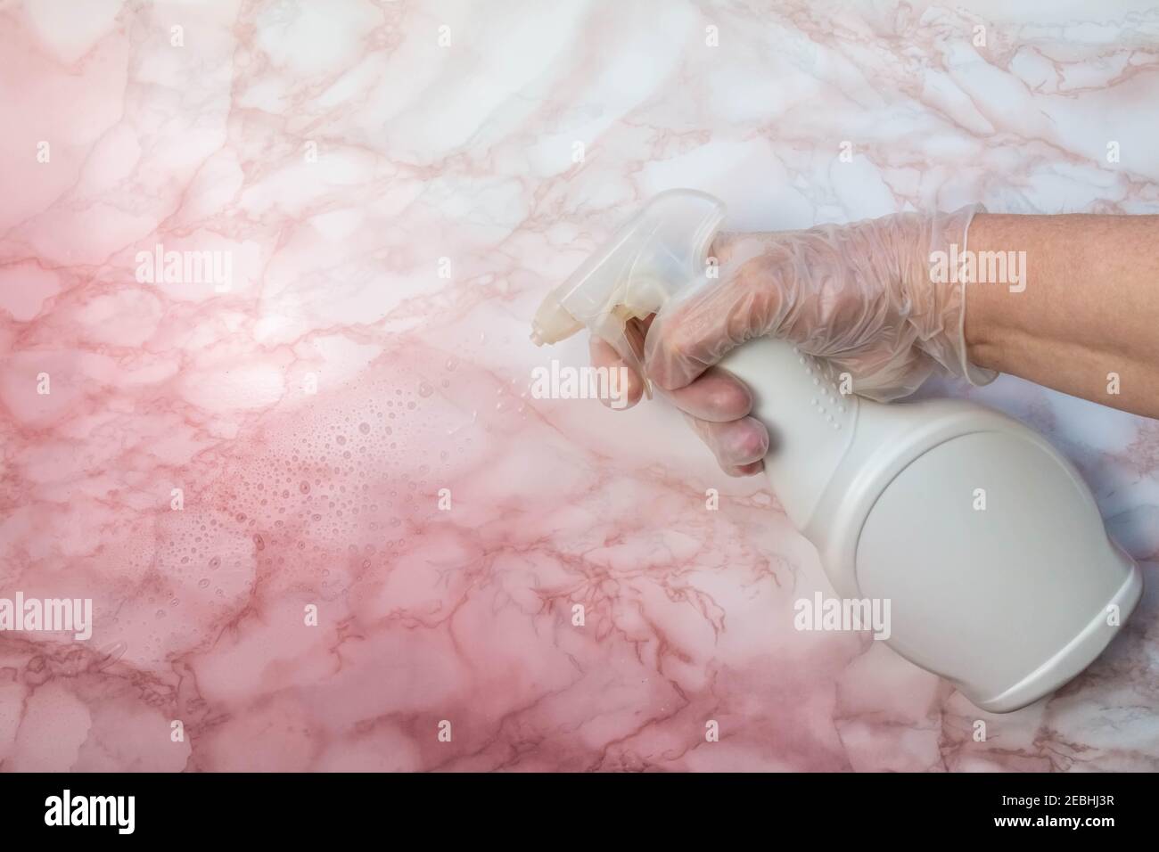 Surface sprayed with disinfectant fluid to kill coronavirus on touching ...