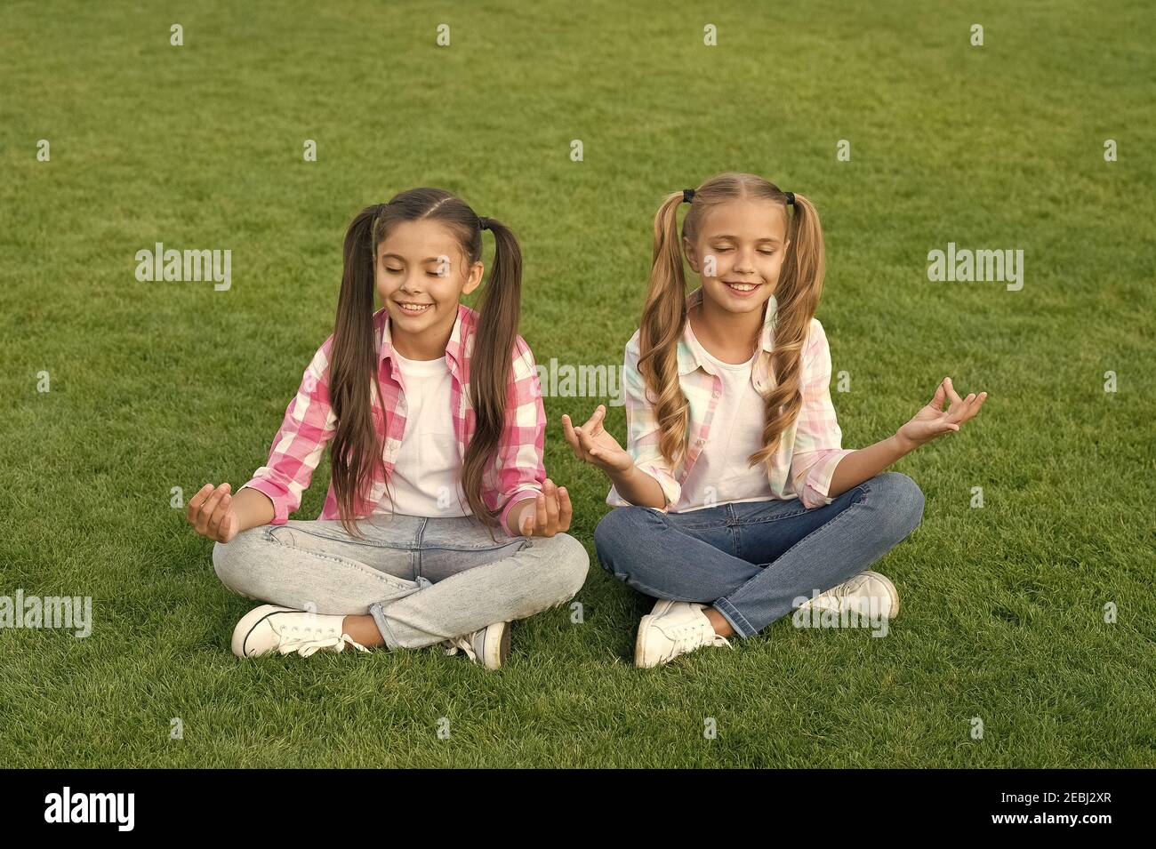 Practicing mudras during meditation. Happy children do meditation on ...