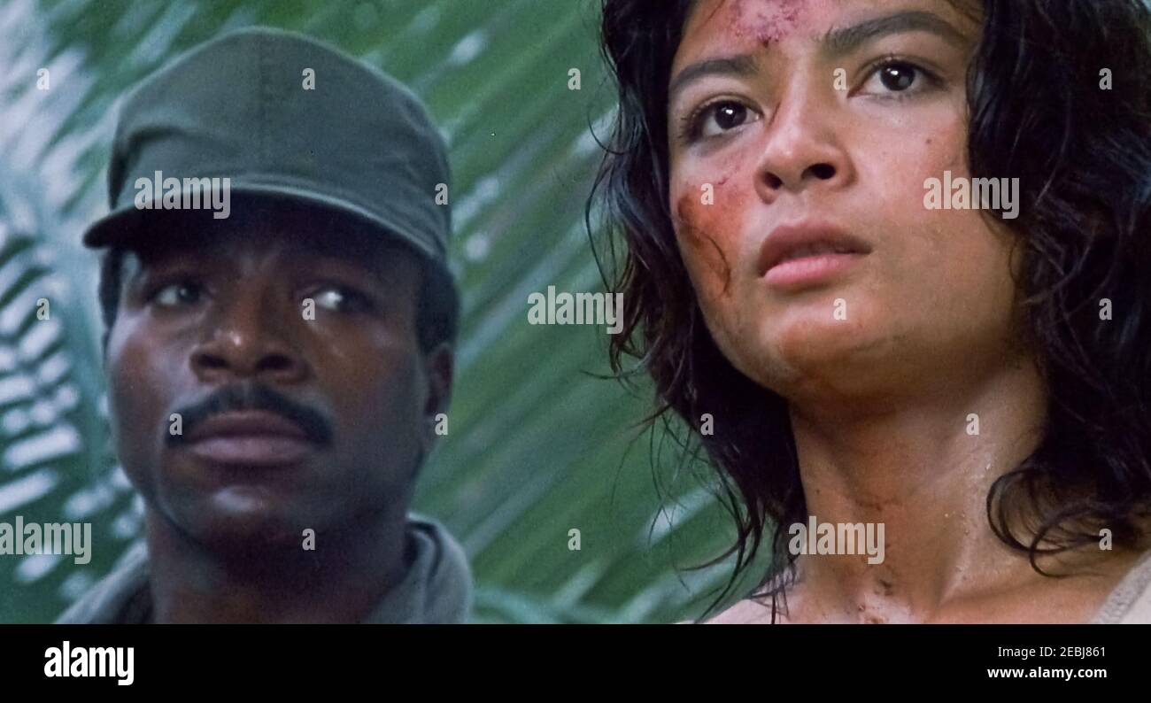 USA. Carl Weathers and Elpidia Carrillo in a scene from the (C ...