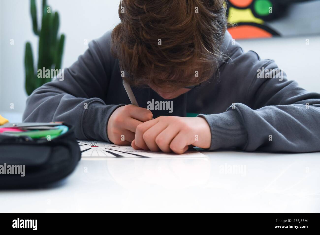 Teen drawing alone at home during covid-19 lockdown. Caucasian young ...