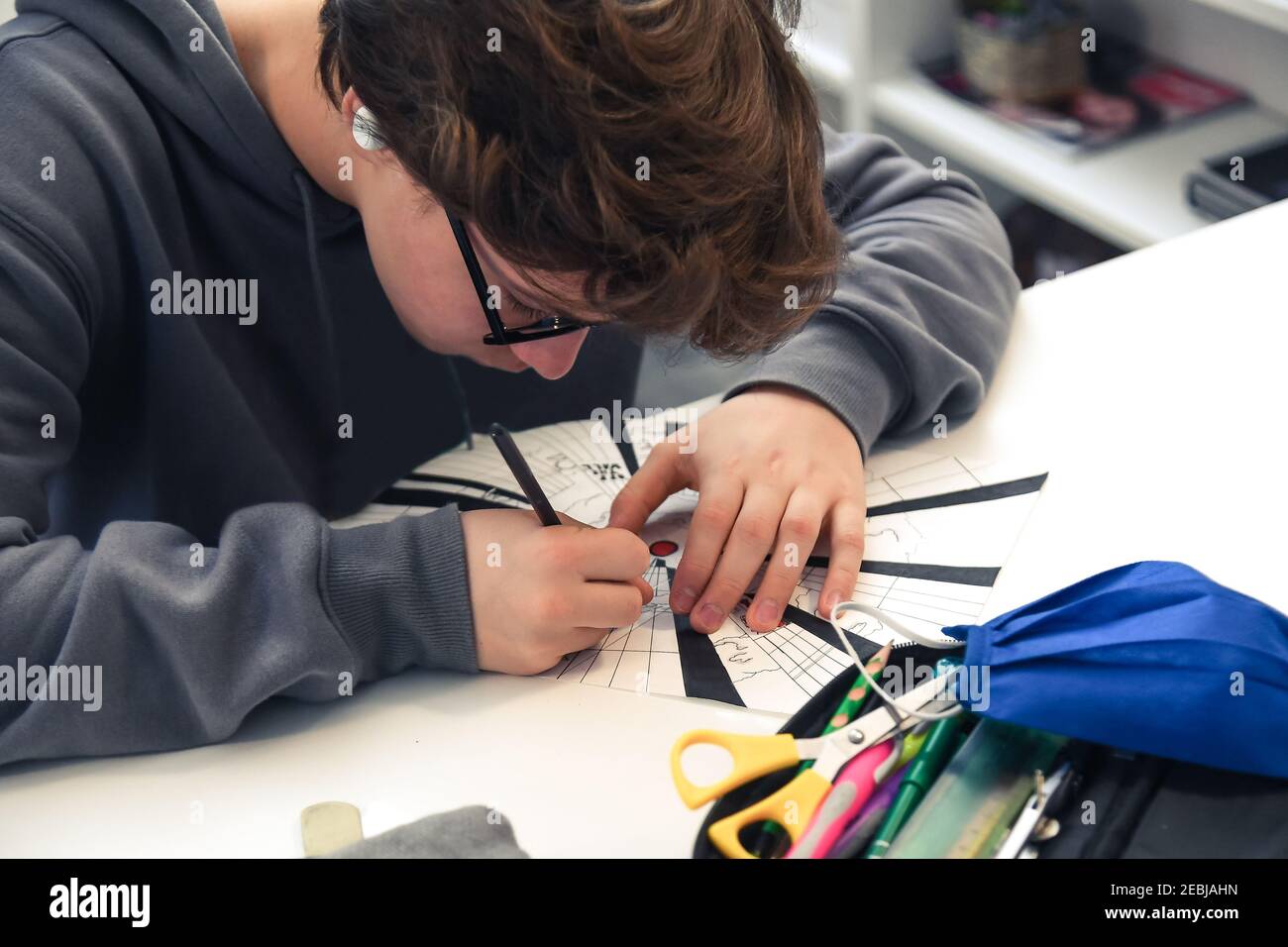 Teen drawing alone at home during covid-19 lockdown. Caucasian young ...