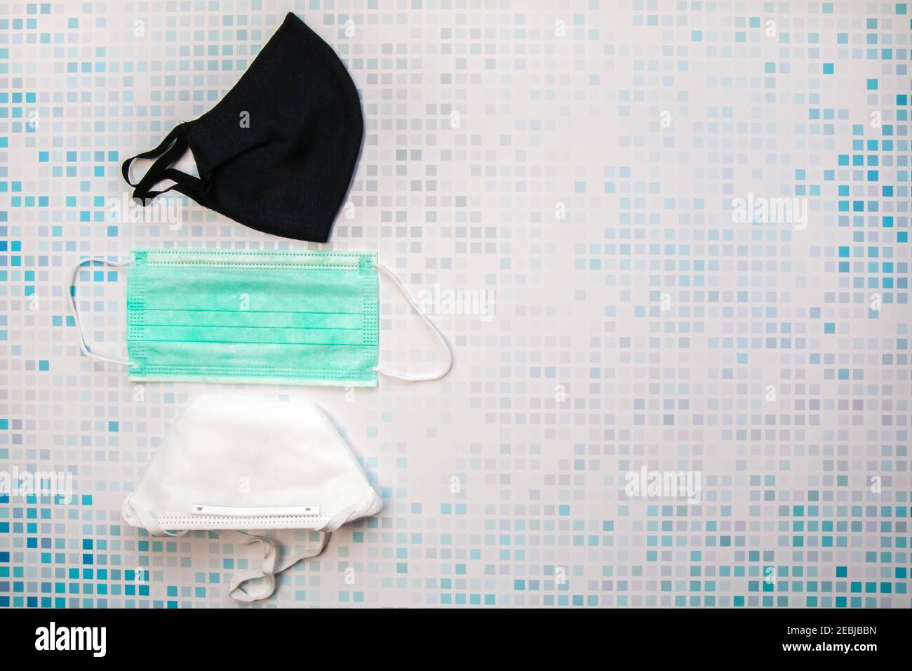 Different types of protective face masks on checkered background ...