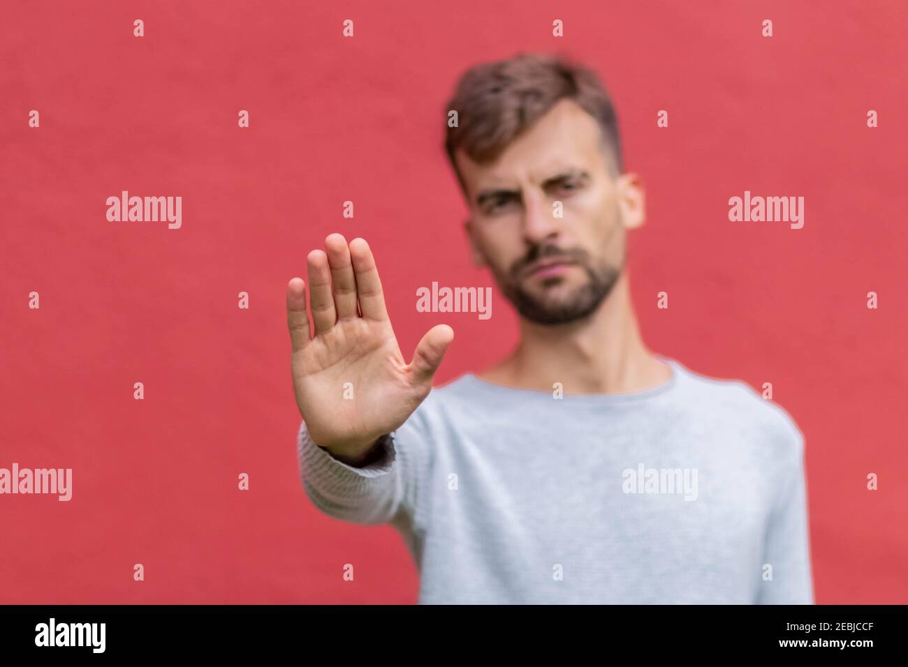Man showing interlocutor hand gesture to keep distance. Guy keeping ...