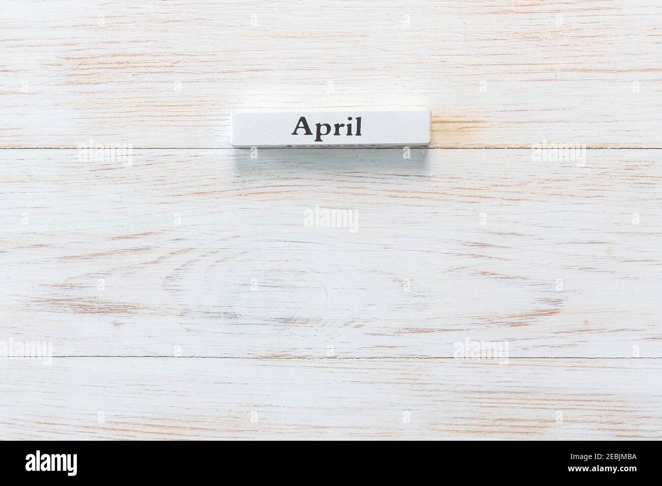 Whine wooden block of calendar with month April on vintage background ...