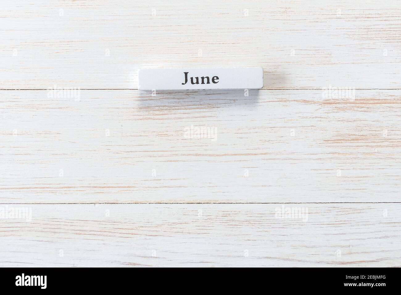 Whine wooden block of calendar with month June on vintage background ...