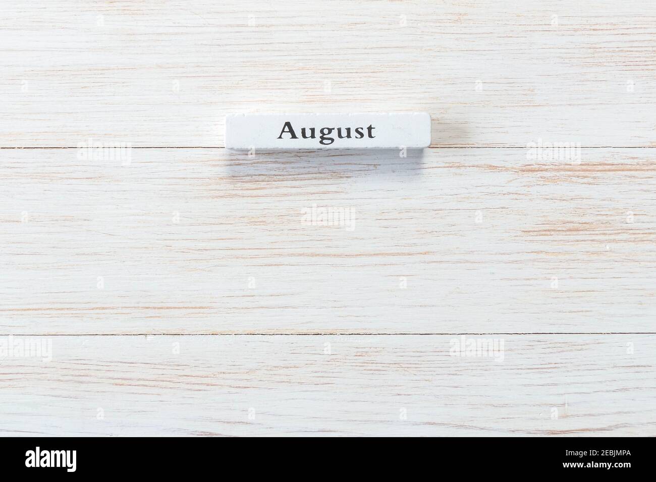 Whine wooden block of calendar with month August on vintage background ...