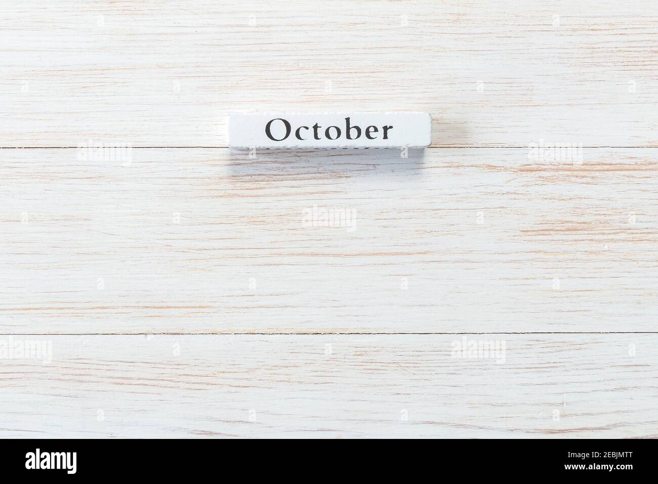 Whine wooden block of calendar with month October on vintage background ...