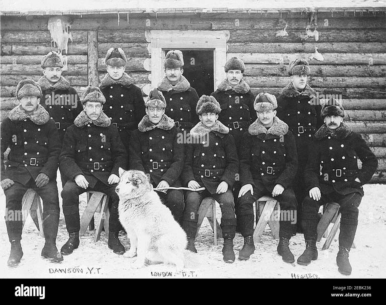 North-West Mounted Police posed for group picture in front of log cabin ...