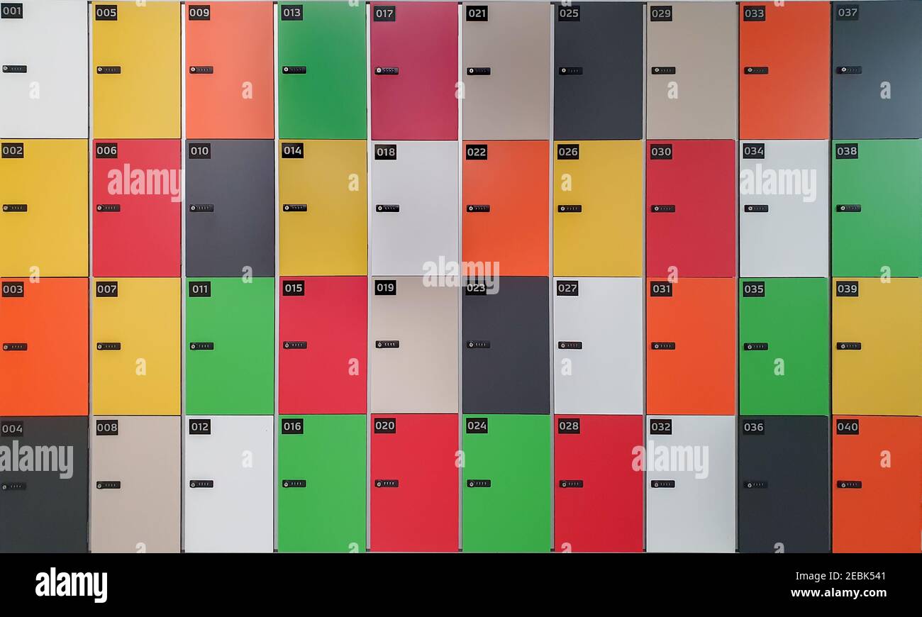 Locker cabinet with locks and numbered lockers in various colors ...