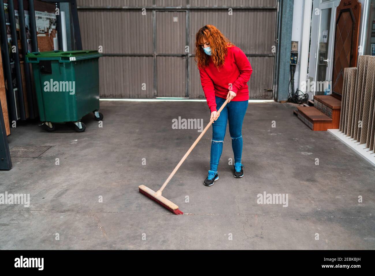 Woman sweeping garage hi-res stock photography and images - Alamy