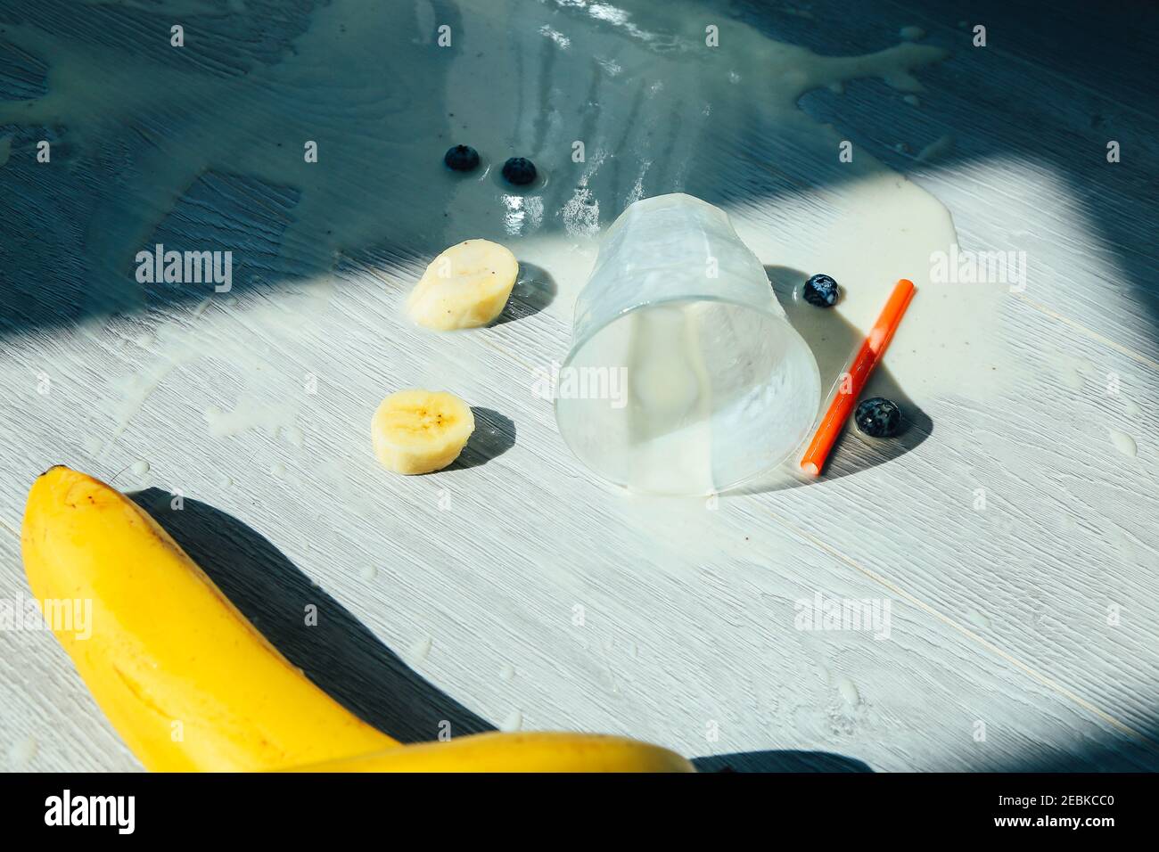 Glass fell to floor and spilled milkshake Stock Photo - Alamy