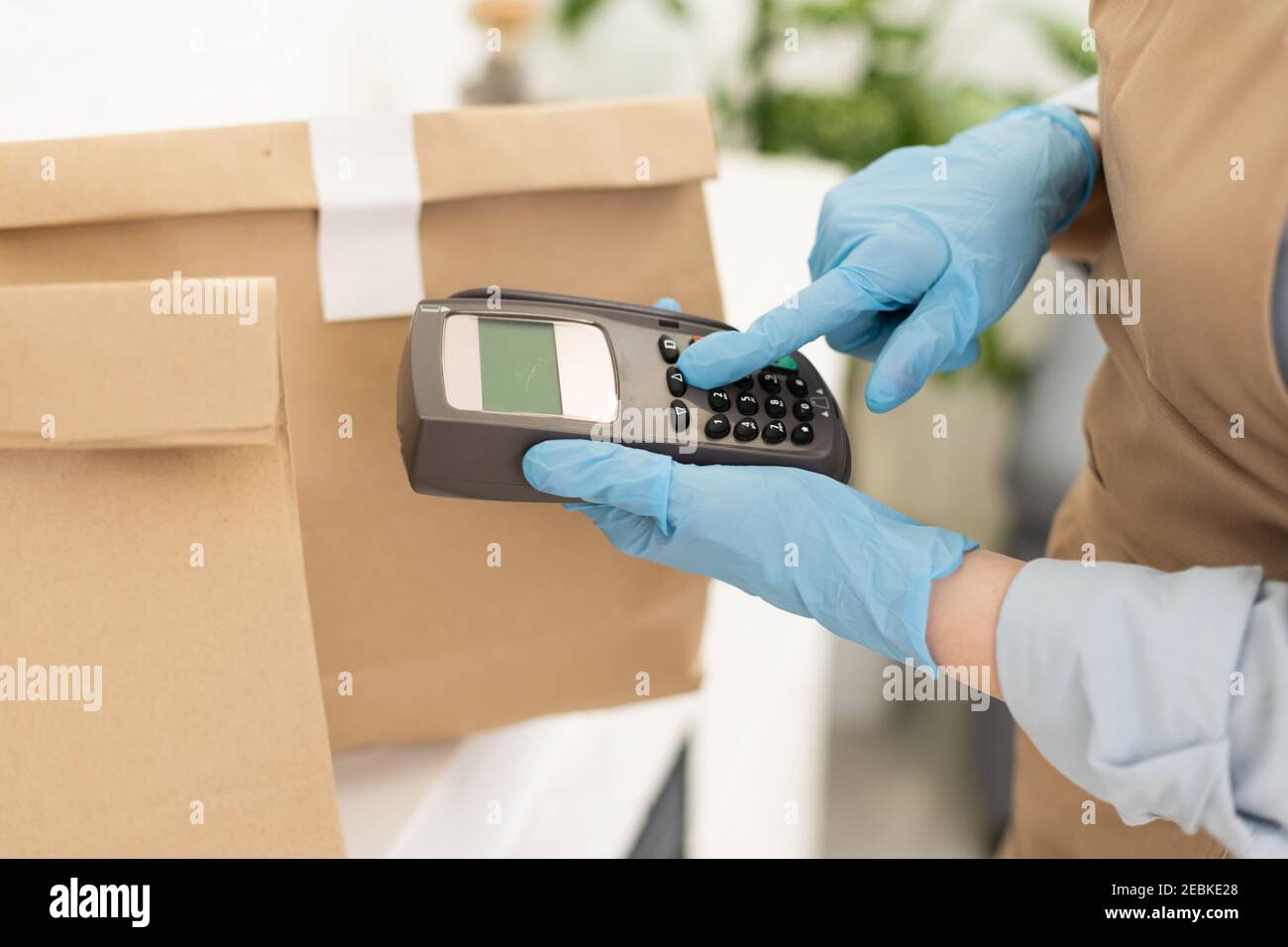 Seller holding payment pos terminal. Space for text Stock Photo - Alamy