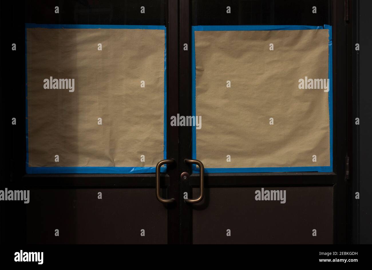brown paper taped to door windows Stock Photo - Alamy