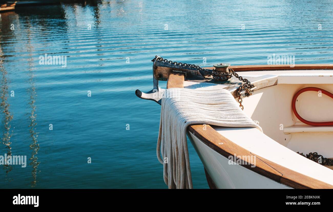 Boat nose with rope on blue waters background with copy space. Nautical ...