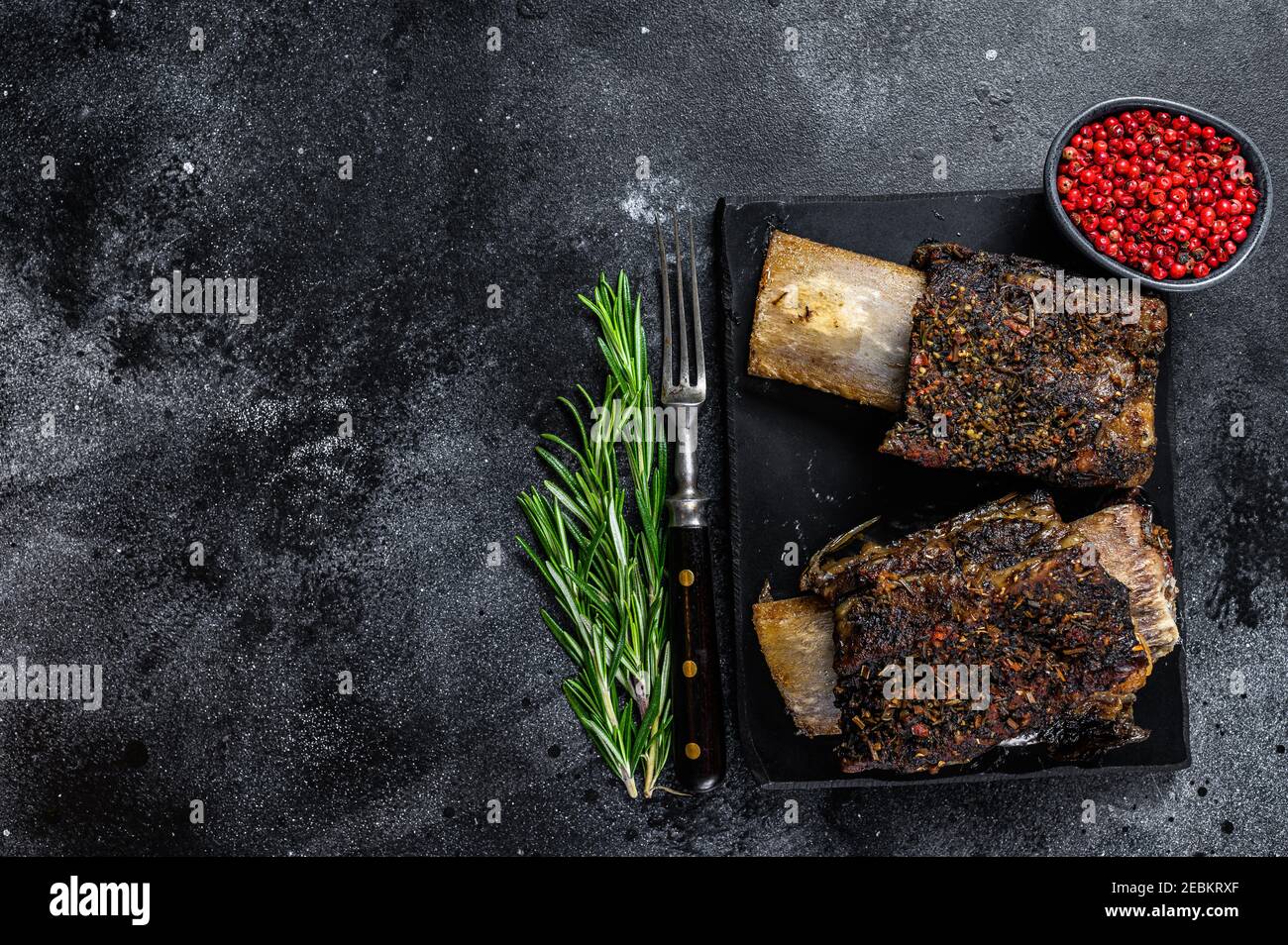 BBQ Beef Short Ribs with herbs. Black background. Top view. Copy space ...