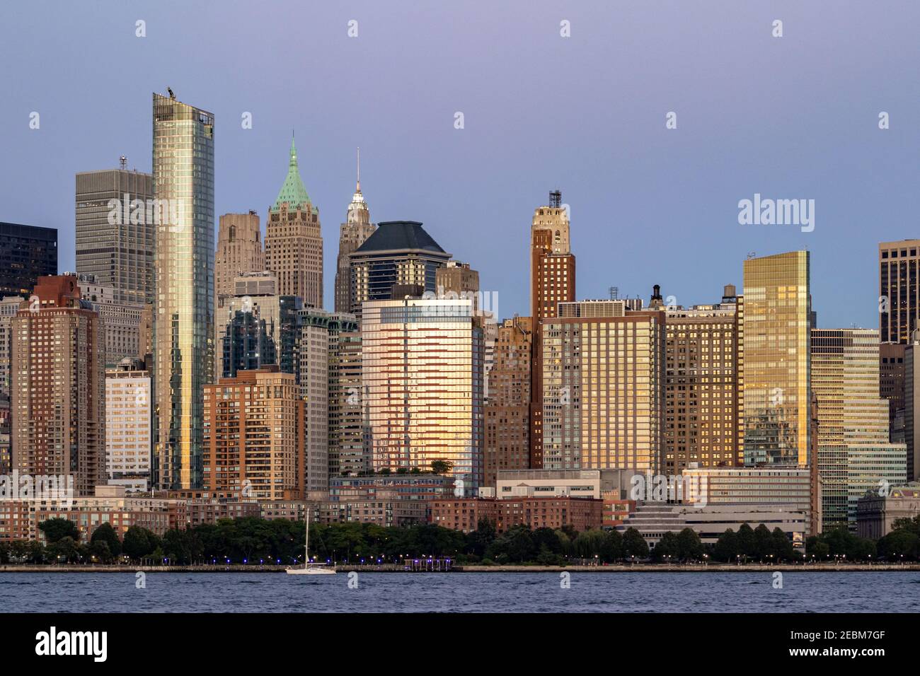 Large stone buildings in downtown New York at sunse Stock Photo - Alamy