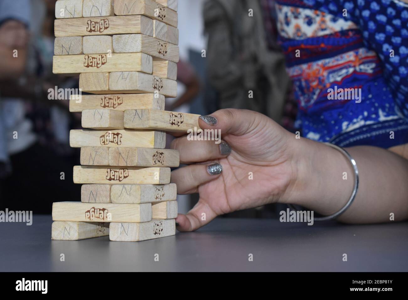 playing jenga .Close up shot of female Male hand playing wooden blocks ...