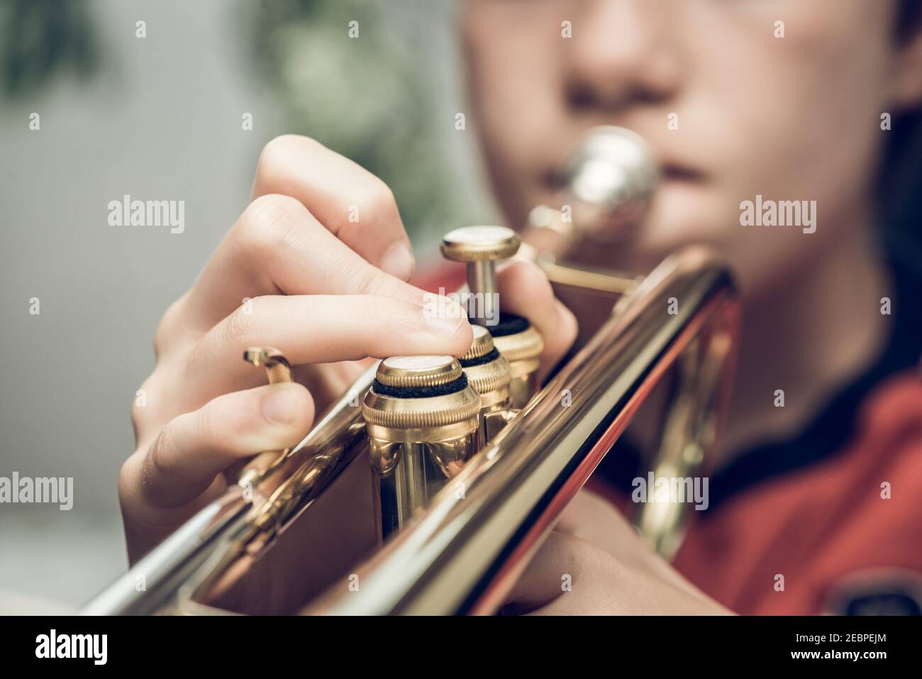 Close up of a child playing a trumpet Stock Photo - Alamy