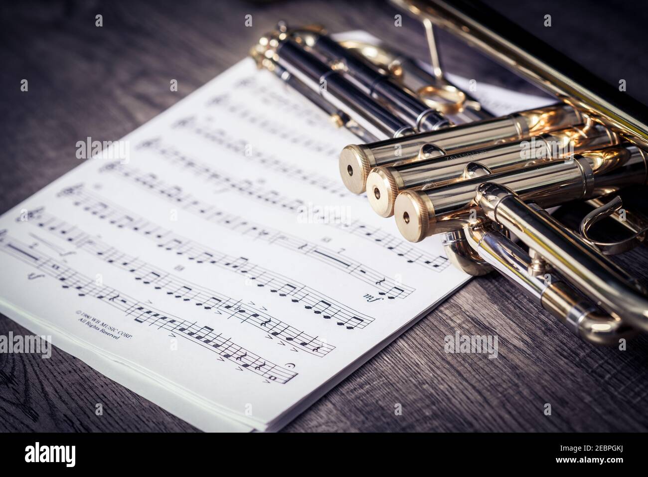 Trumpet and sheet music on a wooden background Stock Photo - Alamy