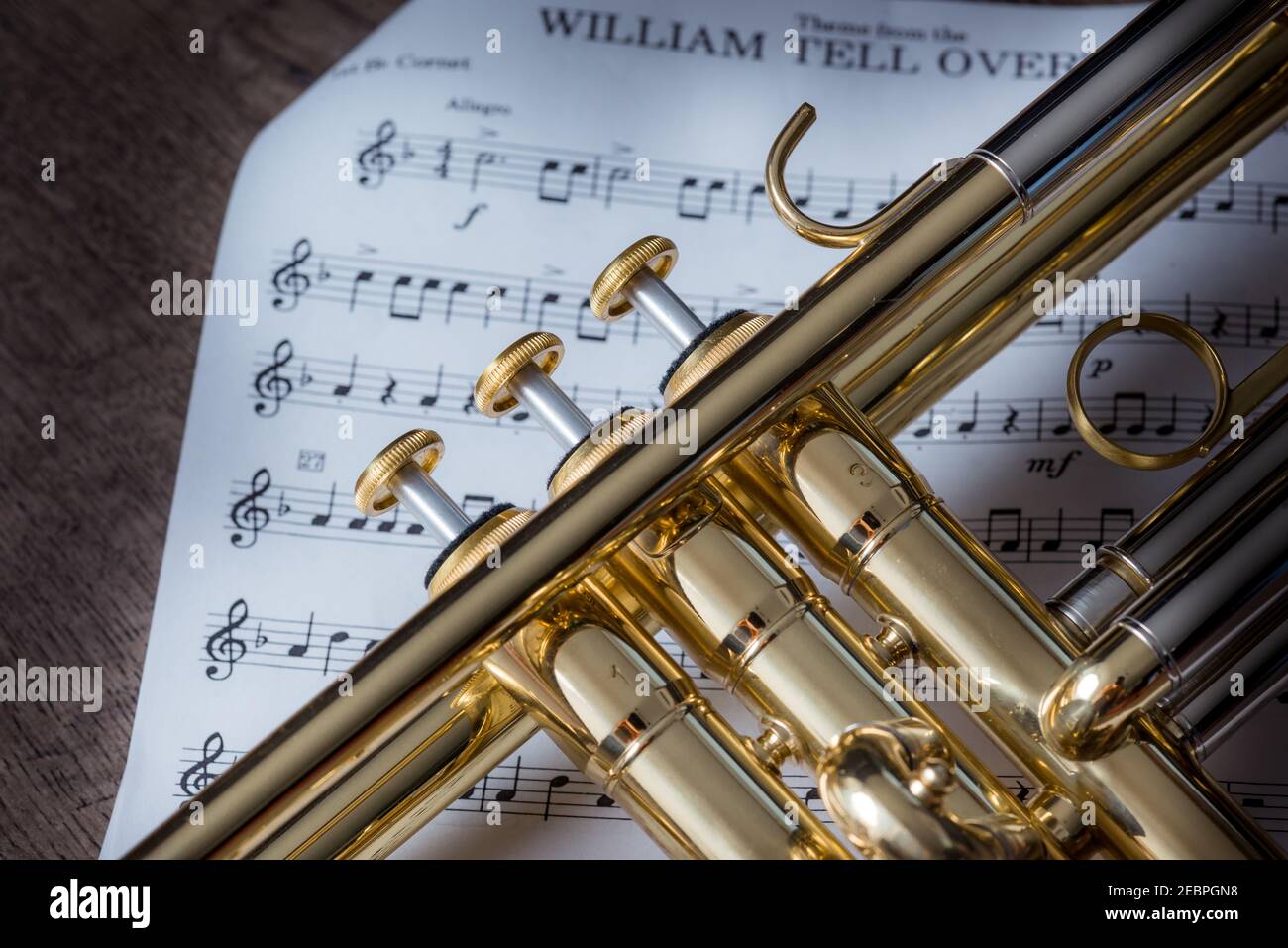 Trumpet and sheet music on a wooden background Stock Photo - Alamy