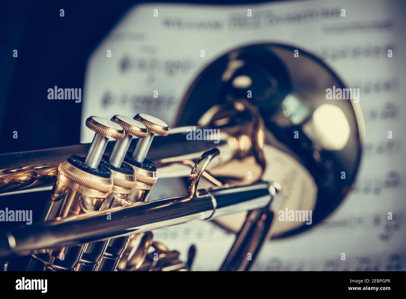Trumpet and sheet music on a wooden background Stock Photo - Alamy