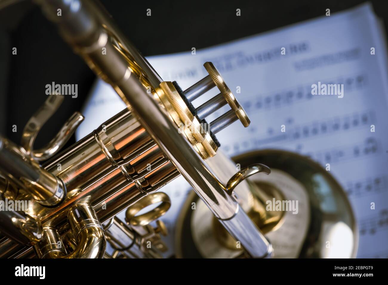 Trumpet and sheet music on a wooden background Stock Photo - Alamy