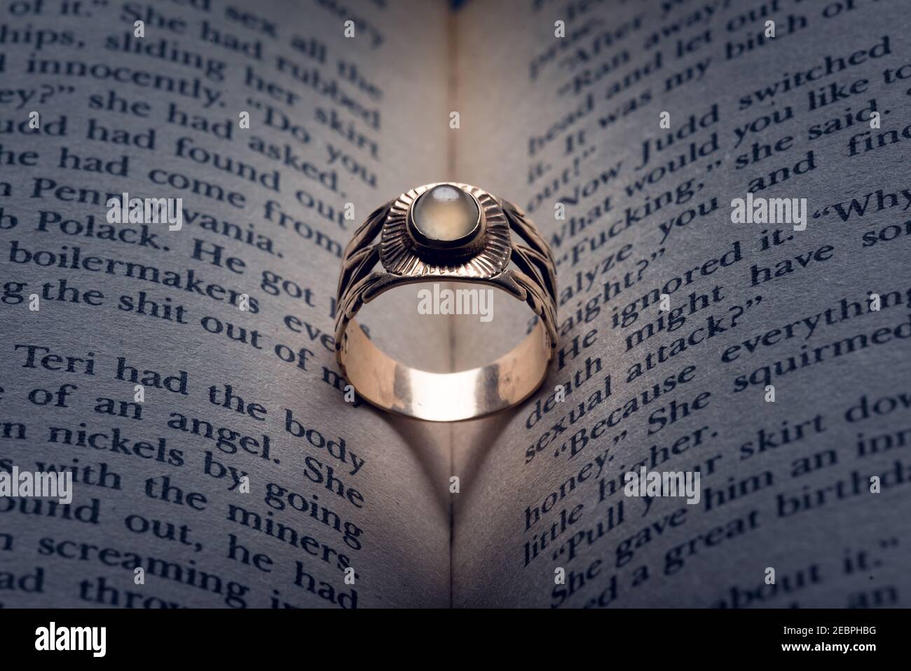 Engagement gold ring on an open book Stock Photo - Alamy